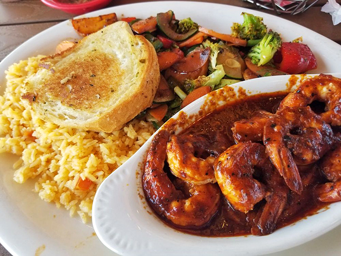 These shrimp look like they've been swimming in flavor before arriving at your table with colorful vegetables and golden rice.