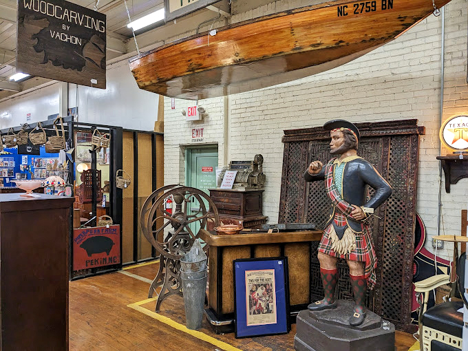 Not your average decor store mannequin, this historical figure stands guard over maritime treasures and wooden wonders.