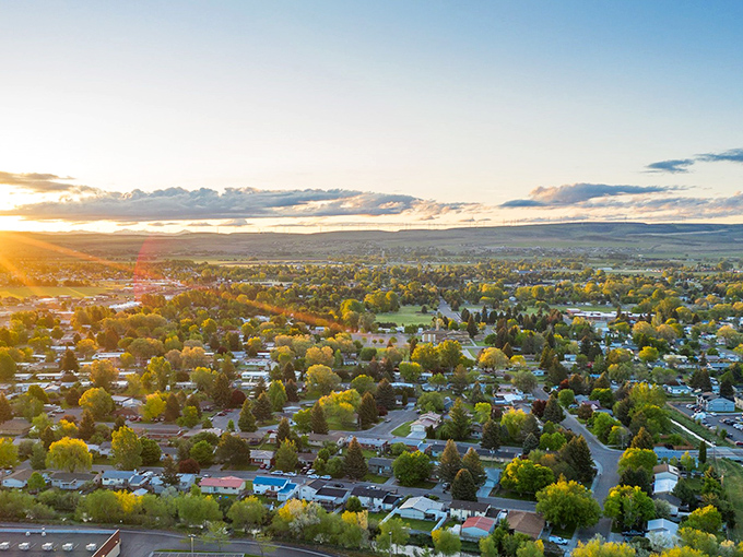 Sunset bathes an Idaho town in golden light, showcasing the perfect blend of nature and community that makes these places postcard-worthy.