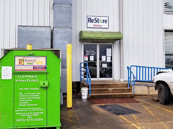 ReStore's entrance might look industrial, but it's actually the gateway to home improvement heaven. The green donation bin stands guard like a recycling sentinel.