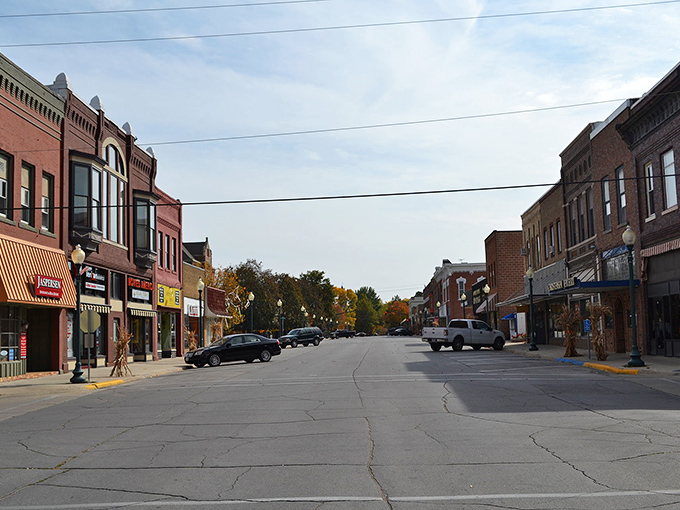 Hampton's historic buildings frame a street where modern cars park alongside vintage architecture.