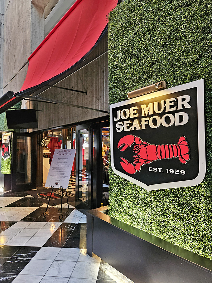 Joe Muer's iconic red lobster sign against the lush green wall &ndash; a Detroit classic that's been tempting taste buds since 1929.