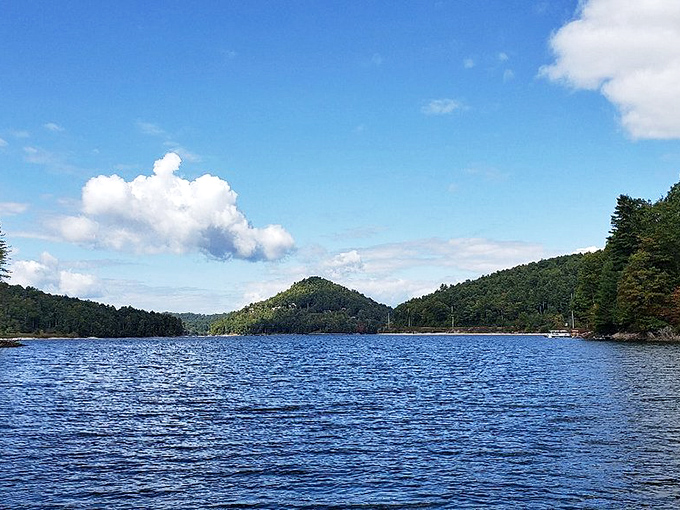 The pristine blue waters near Cashiers reflect mountain majesty. This view alone explains why people fall in love with small-town mountain living.