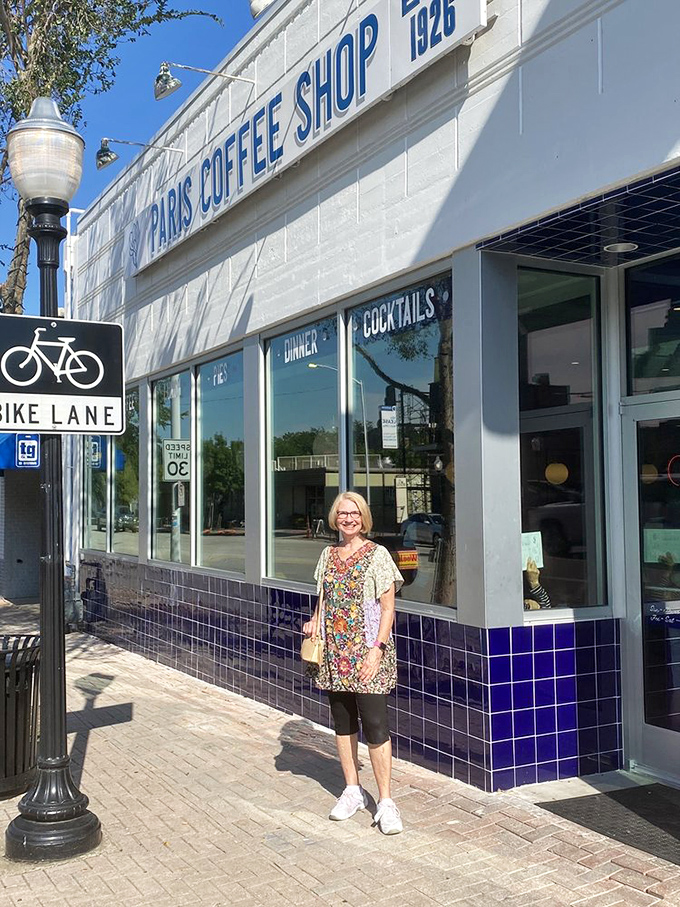 A happy patron stands outside the historic Paris Coffee Shop. When a place has been serving breakfast since 1926, they've clearly cracked the code!