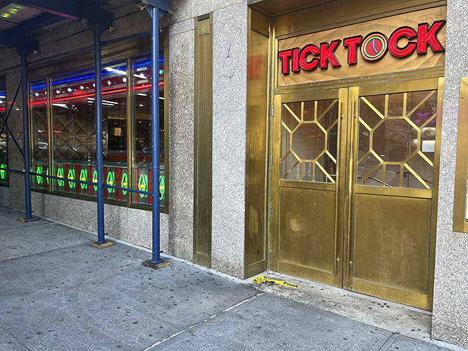 The red TICK TOCK sign glows like a beacon for hungry travelers seeking salvation by the slice or stack.