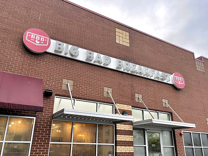The brick fortress of breakfast dreams announces itself with that bold red awning. Big Bad Breakfast isn't whispering its presence&mdash;it's shouting delicious promises.