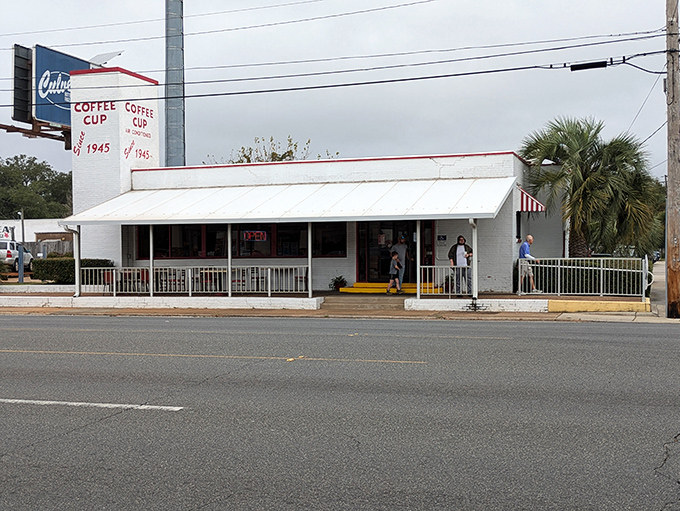 The unassuming exterior of Coffee Cup Restaurant stands like a time capsule amid Pensacola's palm trees, promising authentic flavors rather than Instagram moments.