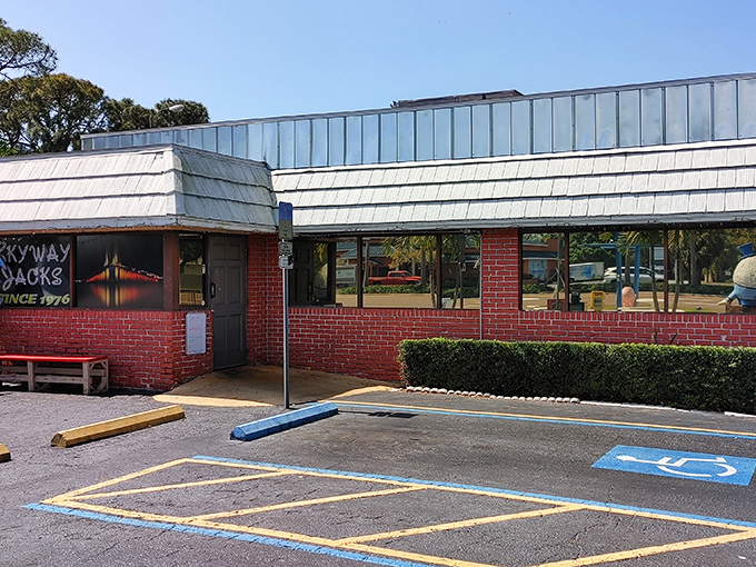 The iconic red brick exterior of Skyway Jack's, complete with its mascot chicken standing guard. Florida breakfast doesn't get more authentic than this.