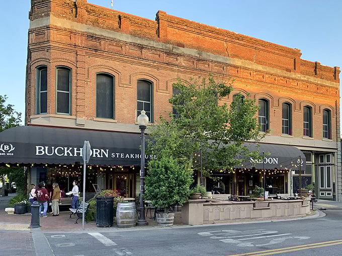 The historic brick fa&ccedil;ade of Buckhorn Steakhouse glows golden at sunset, a beacon of carnivorous delights in downtown Winters that's impossible to resist.