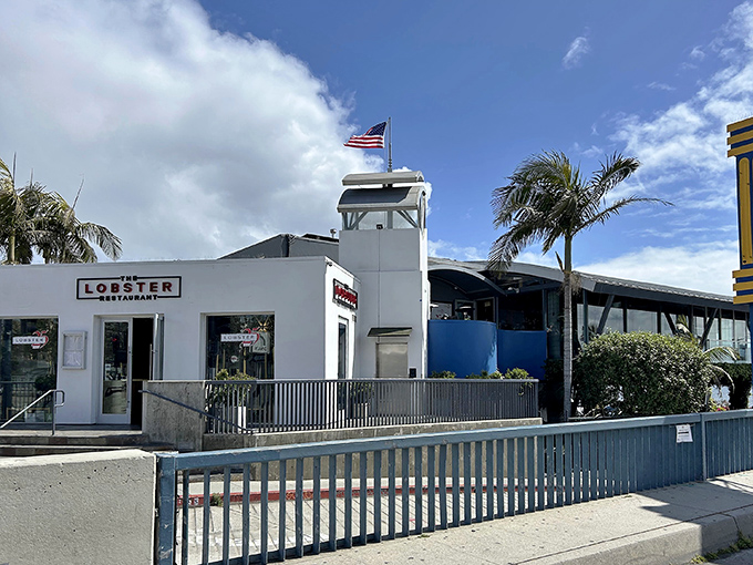 The pristine white exterior of The Lobster beckons seafood lovers at the entrance to Santa Monica Pier, promising oceanic delights with unbeatable views.