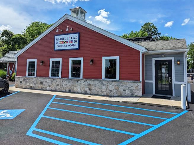 The iconic red barn exterior of Marblehead Chowder House stands like a lighthouse for seafood lovers, beckoning hungry travelers with promises of coastal delights.