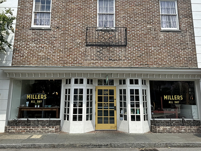 The charming storefront of Millers All Day beckons with its classic brick exterior and cheerful yellow door&mdash;like Charleston itself, both elegant and welcoming.
