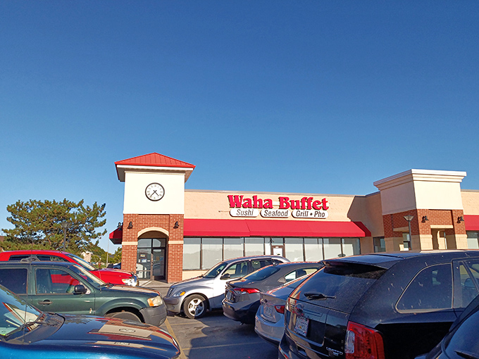 The bright red signage of Waha Buffet stands out like a culinary lighthouse, beckoning hungry travelers with promises of sushi, seafood, and pho paradise.
