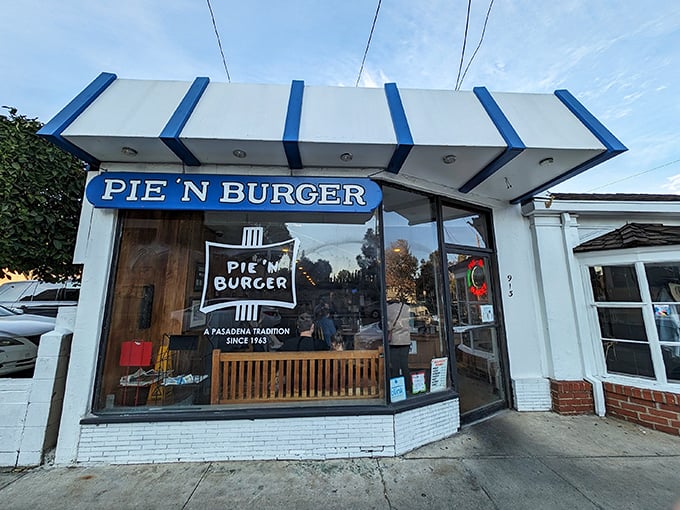 The iconic blue-trimmed storefront beckons like a time portal to simpler days when burgers were burgers and pies were the grand finale, not an afterthought.