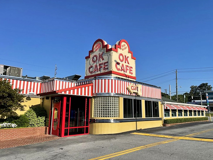 The iconic red and white striped awning of OK Cafe stands out against the Atlanta sky like a beacon for hungry souls seeking Southern comfort.