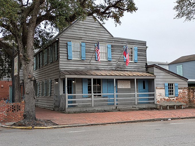 The weathered clapboard exterior and ancient oak tree whisper tales of seafaring rogues who once stumbled through these doors after months at sea.