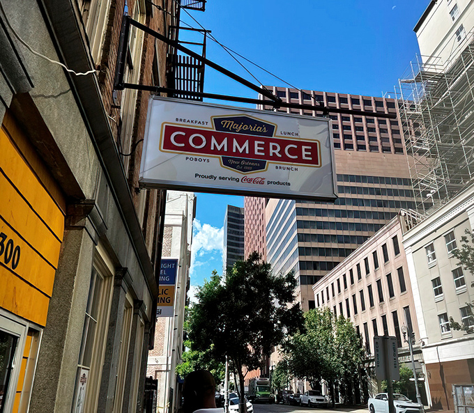 The iconic red awning of Majoria's Commerce Restaurant stands out against historic brick, a beacon for breakfast pilgrims in New Orleans' CBD. 