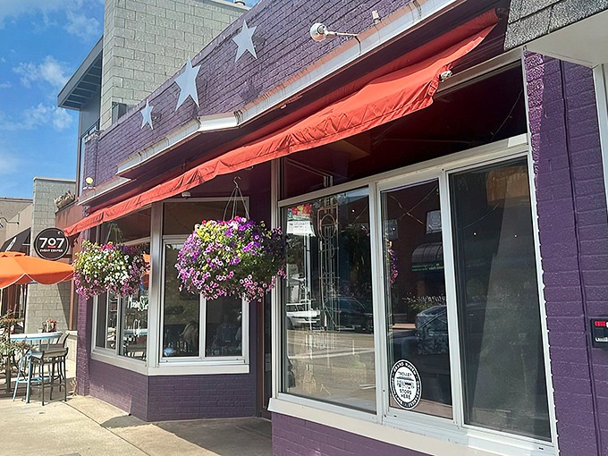 The purple facade with its cheerful red awning and hanging flower baskets isn't just eye-catching&mdash;it's nature's way of saying "breakfast is served!"