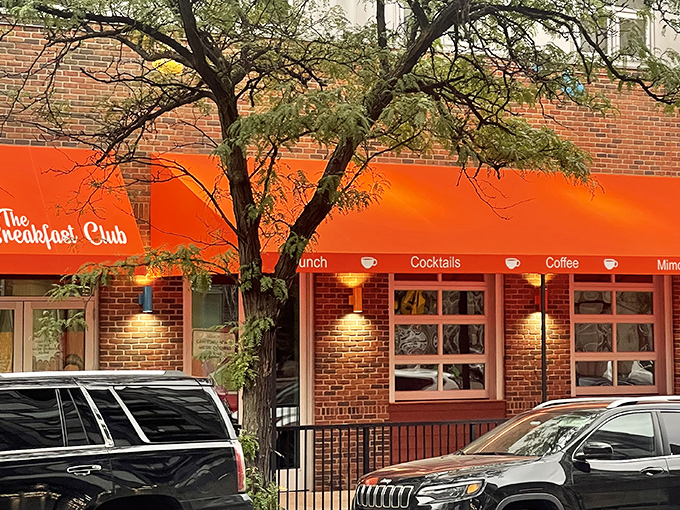 The vibrant red awning of The Breakfast Club MPLS beckons breakfast enthusiasts like a culinary lighthouse guiding hungry souls through Minneapolis mornings.