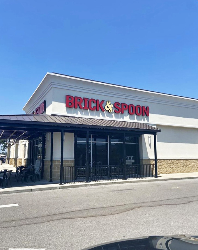 The red signage of Brick & Spoon gleams like a beacon for breakfast lovers. The patio beckons with promise of morning feasts and mimosa-fueled conversations.