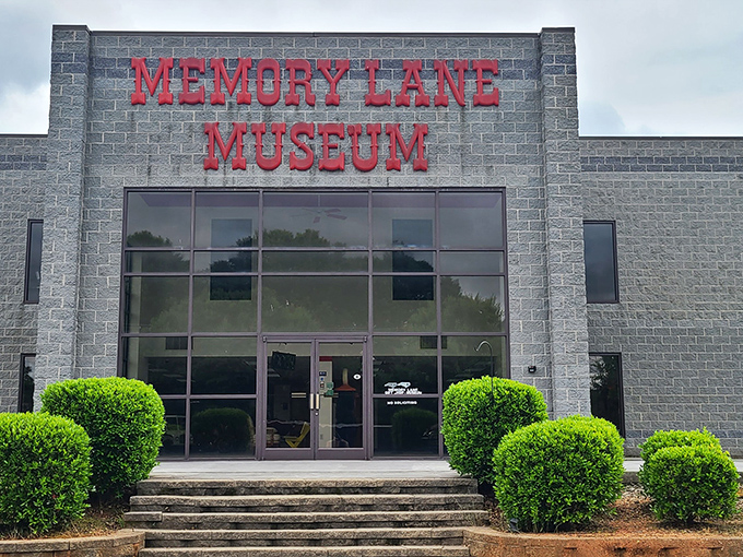The unassuming exterior of Memory Lane Museum belies the automotive wonderland within, much like finding a V12 engine under the hood of your grandmother's station wagon.