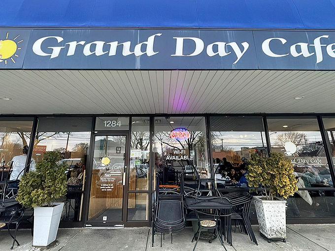 The blue awning of Grand Day Cafe beckons like a breakfast lighthouse guiding hungry souls to hash brown paradise.