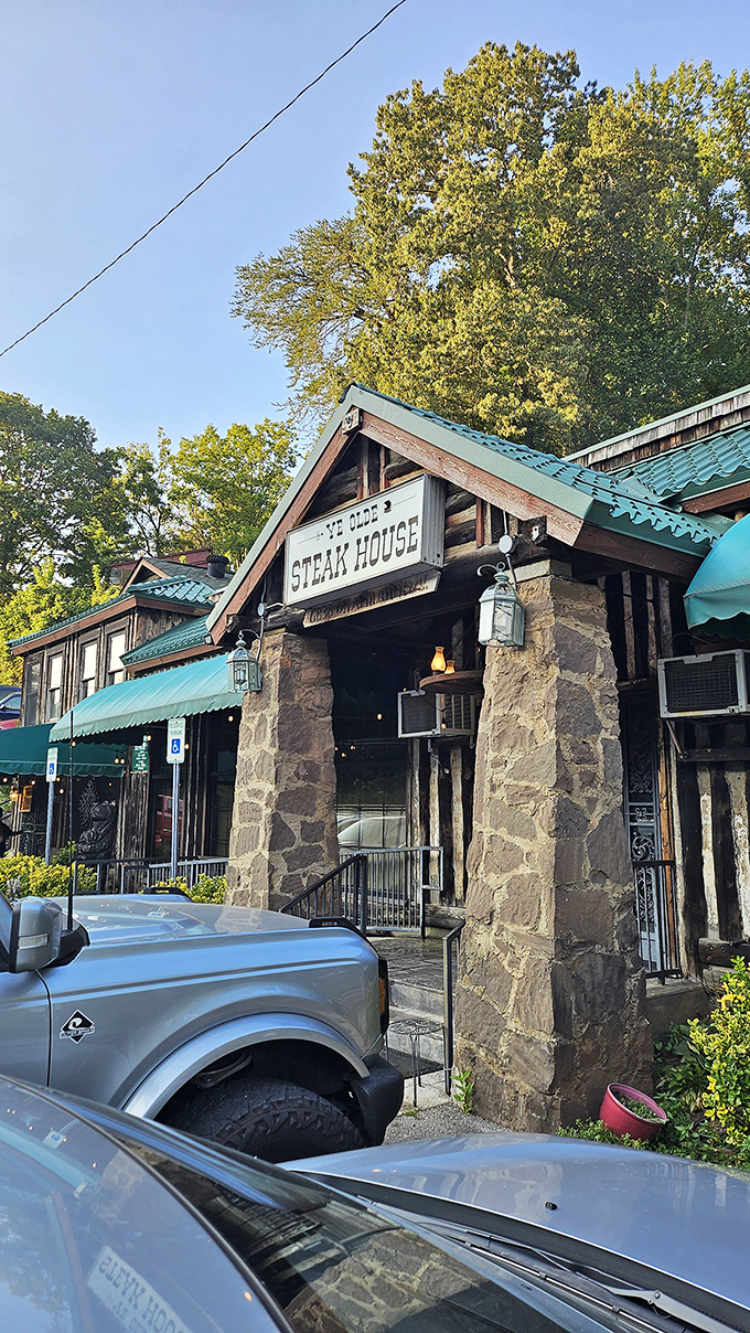 The stone facade and illuminated sign of Ye Olde Steak House beckons like a carnivore's lighthouse on a dark Tennessee night.