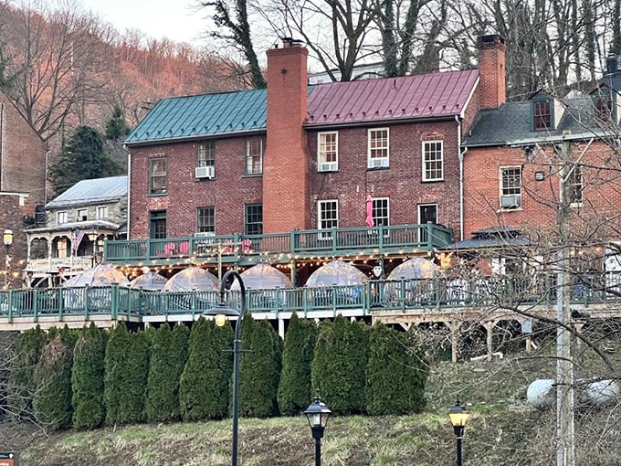 The brick exterior of The Rabbit Hole beckons like a storybook invitation, complete with climbing roses and mountain views that make waiting for a table feel like a vacation.