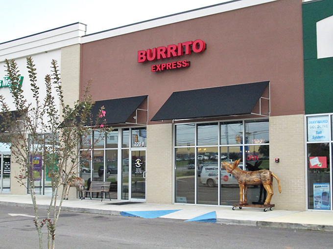 The unassuming storefront of Burrito Express, complete with wooden donkey sentinel, proves that culinary treasures often hide in plain sight.
