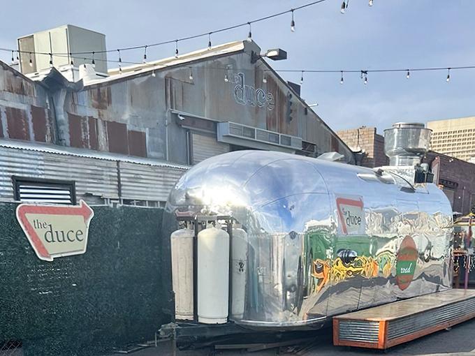 The Duce's exterior is industrial chic personified&mdash;corrugated metal, vintage signage, and that gleaming Airstream trailer promising culinary adventures within.
