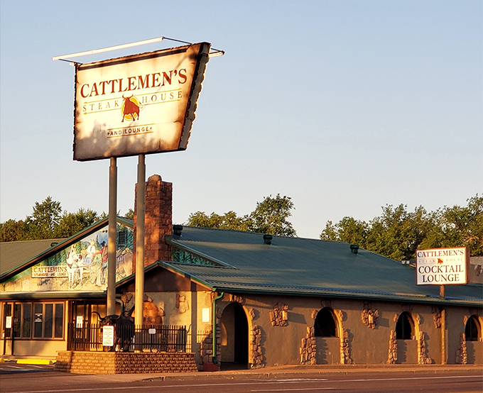 The iconic Cattlemen's sign stands tall against the Arizona sky, beckoning hungry travelers like a beef-scented lighthouse in the White Mountains.