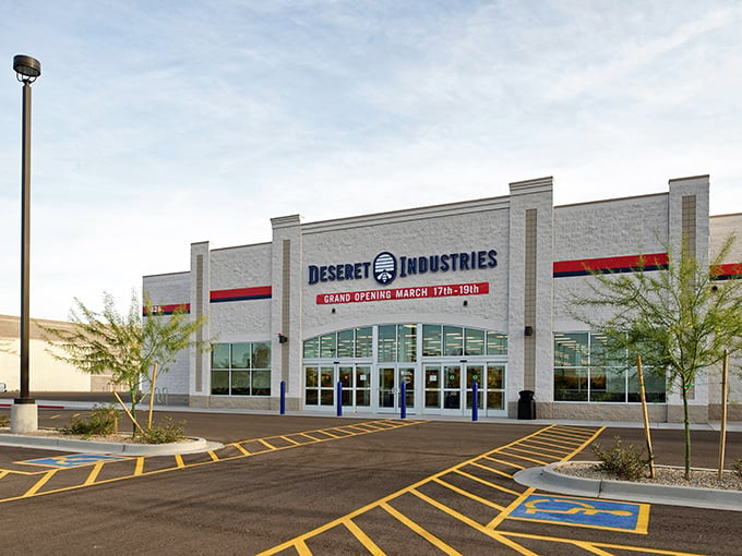 The modern facade of Deseret Industries beckons with promises of treasures within—like a department store where everything comes with a story.