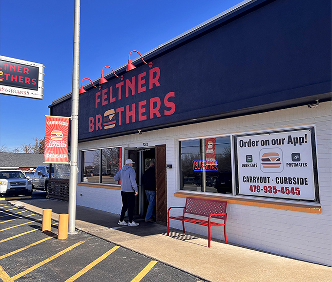 The red and black signage stands like a beacon of burger hope against the Arkansas sky. Simple, straightforward, and promising delicious things inside.