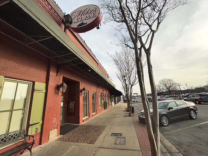 The brick-red exterior of Mike's Place stands as Conway's culinary beacon, its green shutters and vintage sign promising delicious adventures within.