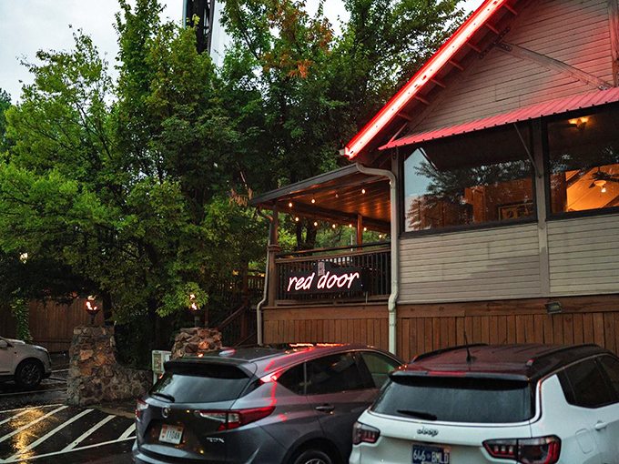 Welcome to culinary paradise! The charming exterior of Red Door, with its signature red trim and inviting wooden staircase, promises delicious adventures within.