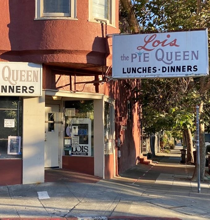 The pink corner building that houses Lois the Pie Queen stands as an Oakland landmark, promising Southern comfort in California sunshine.