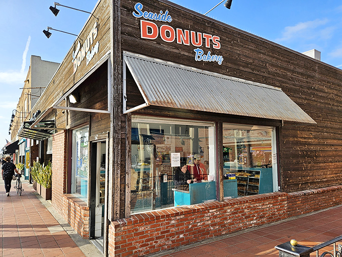 Palm trees stand sentry outside Seaside Donuts' wooden facade, nature's exclamation points announcing: "Something delicious happens here!"
