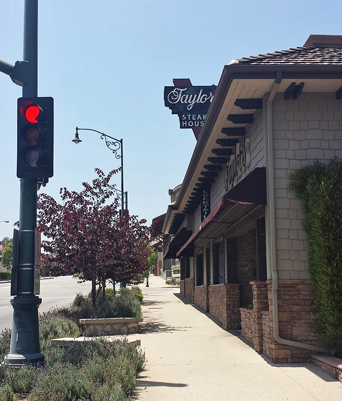 The iconic Taylor's sign beckons meat lovers like a lighthouse guiding hungry sailors home. Classic stone facade and vintage charm promise authentic steakhouse experience.
