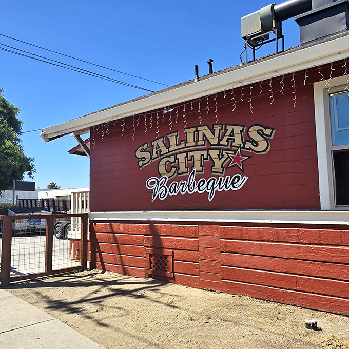 The little red barbecue house that could. With its cheerful yellow door and string lights, this unassuming spot is where smoke dreams come true.