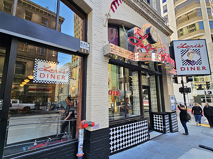 The neon glow of Lori's Diner beckons like a lighthouse for the hungry, promising a journey back to simpler, chrome-plated times.