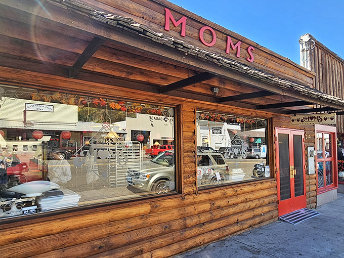 The rustic log cabin exterior of Mom's Pie House beckons like a siren song to pie lovers. Those red doors might as well be portals to dessert heaven.