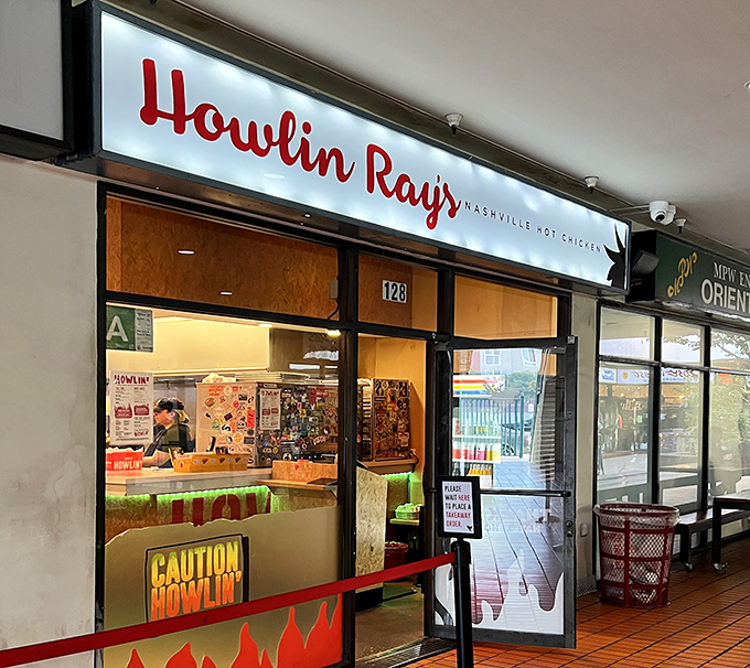 The fiery entrance to Howlin' Ray's beckons brave souls with its flame-adorned doors. This isn't just dinner—it's a delicious dare.