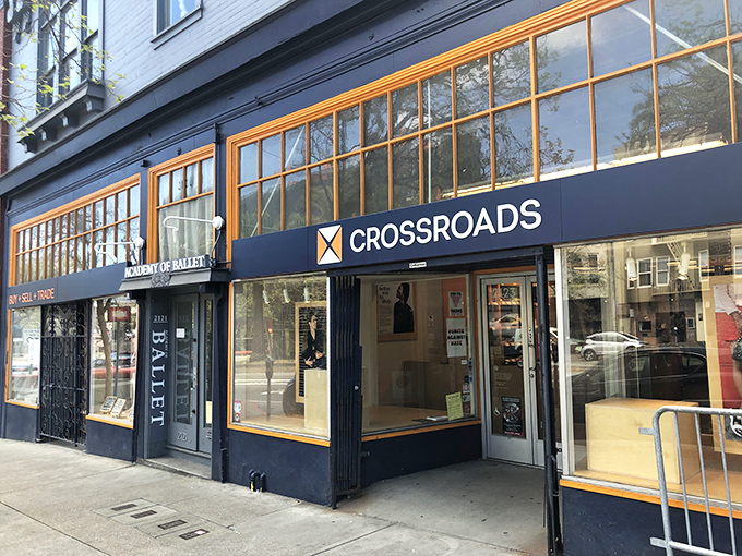 The distinctive navy blue and orange storefront of Crossroads Trading stands out like a fashion oasis on San Francisco's bustling streets.