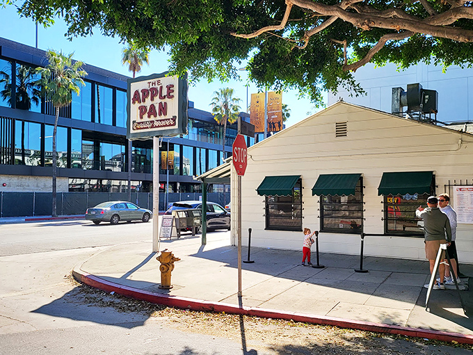 The unassuming white exterior of The Apple Pan stands like a time capsule on West Pico Boulevard, its vintage sign promising "Quality Forever" &ndash; a bold claim it's managed to fulfill for decades.