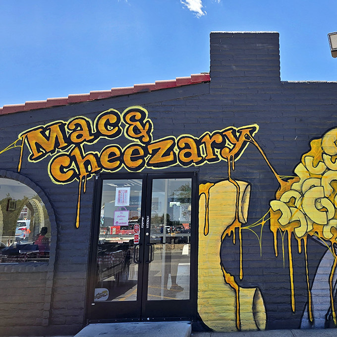 The blue building with dripping yellow cheese art isn't subtle about its mission. Like a cheese-themed Bat Signal calling comfort food lovers home.