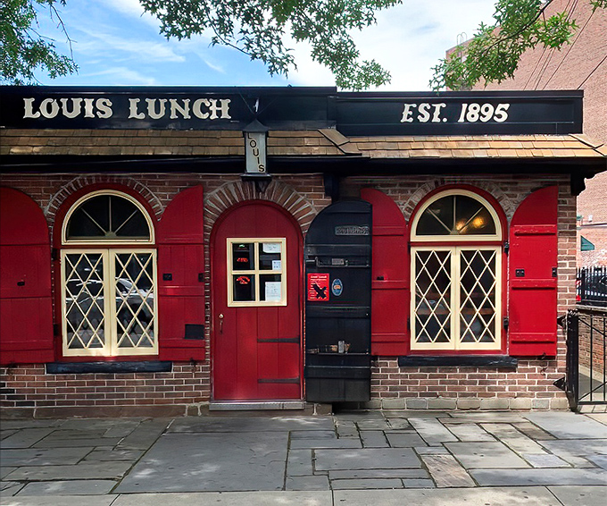 The little red brick building that changed America's culinary landscape forever. Louis' Lunch stands proudly in New Haven, a burger shrine disguised as a modest diner.
