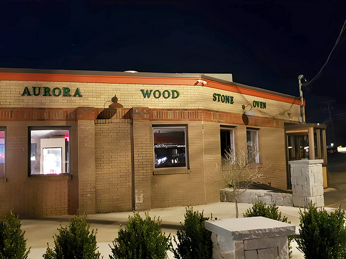 The classic roadside charm of Aurora Diner beckons hungry travelers with its promise of comfort food and that unmistakable blue-umbrella welcome.