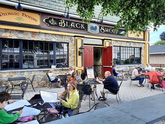 The stone facade and iconic red doors of The Black Sheep stand like a culinary lighthouse on Niantic's shore, beckoning hungry travelers with promises of exceptional fare.