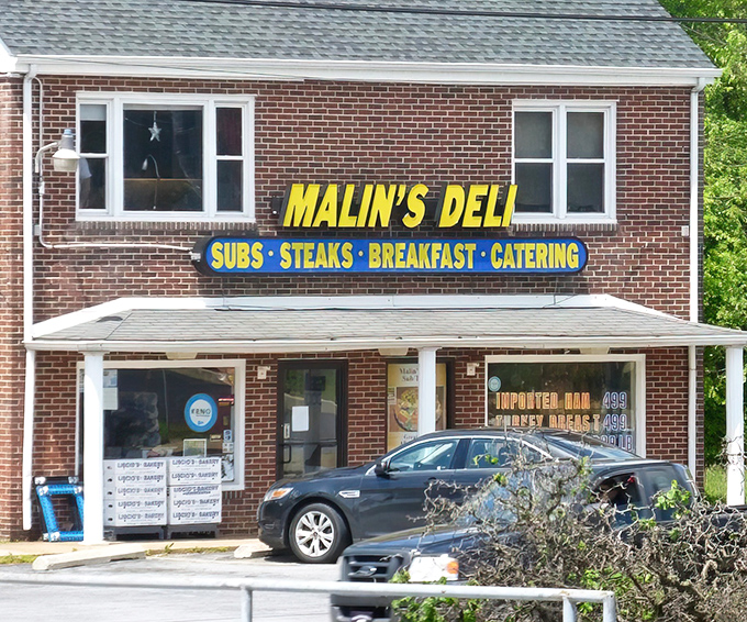 The brick fa&ccedil;ade of Malin's Deli stands as a beacon of sandwich salvation in Newark, promising subs, steaks, breakfast, and catering to hungry Delawareans.