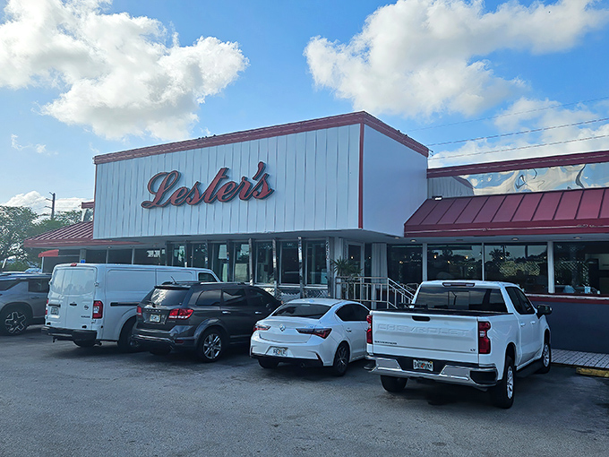 The iconic red and white exterior of Lester's Diner stands like a time capsule of Americana, beckoning hungry travelers with promises of comfort food paradise.